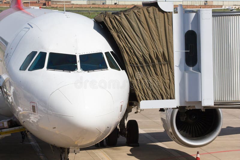 Airplane with Bridge Attached Stock Image - Image of engine, jetliner ...