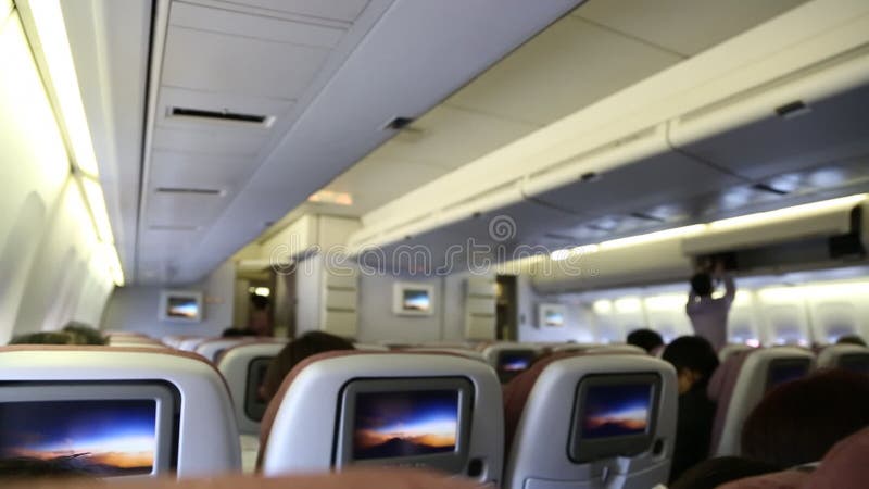 Airplane Cabin with Passengers Sitting and Save the Luggage. Inside ...