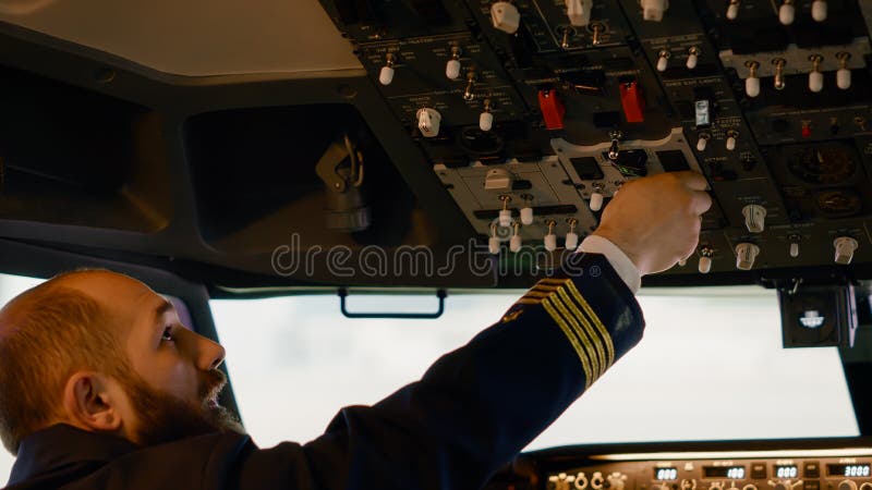 Airplane Captain Starting Engine with Power Buttons on Dashboard Stock ...