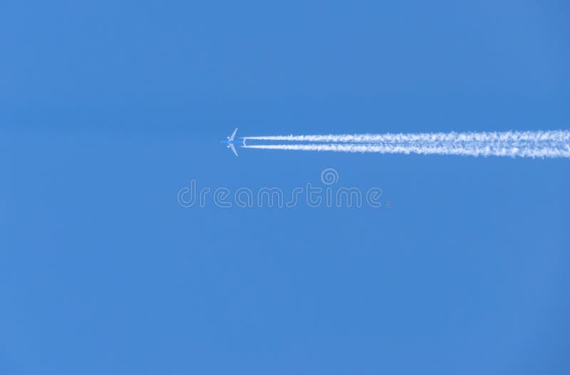Airplane with Contrails Against Blue Sky #1 Stock Image - Image of ...