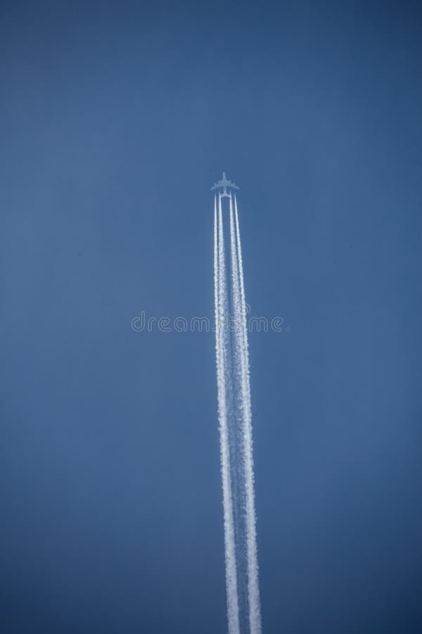 Airplane with Contrails in the Blue Summer Sky Stock Image - Image of ...