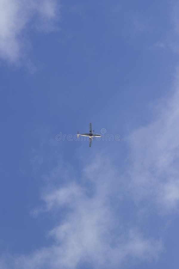 Airplane in Distance, Centered in a Blue Sky with Light Clouds. Stock ...
