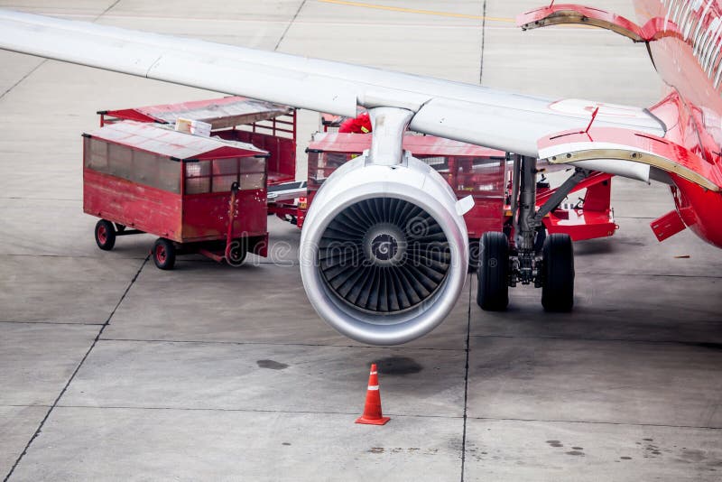 Airplane Engine in Front of Loading Luggage from Airplane Stock Photo ...