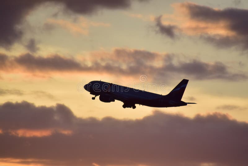 Airplane in the Evening Sky Stock Image - Image of clouds, flight ...