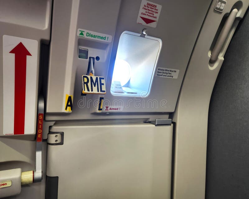 Airplane Exit Hatch with Warning Signs, Unarmed Stock Image - Image of ...