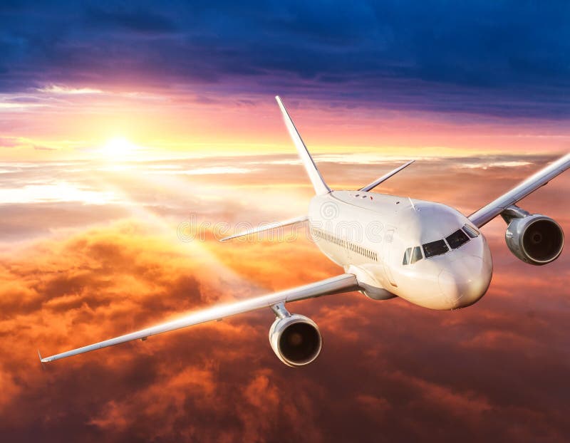 Airplane Flying Above Clouds in Dramatic Sunset Stock Photo - Image of ...
