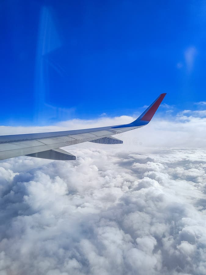 Airplane Flying Above the Clouds - Wing in the Sky Stock Photo - Image ...