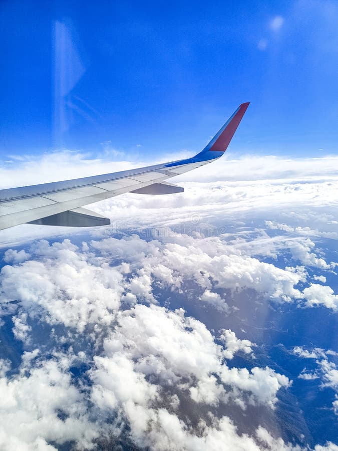 Airplane Flying Above the Clouds - Wing in the Sky Stock Photo - Image ...