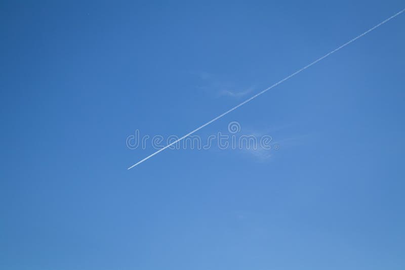 Airplane Flying Across a Solid Blue Sky Stock Image - Image of blue ...