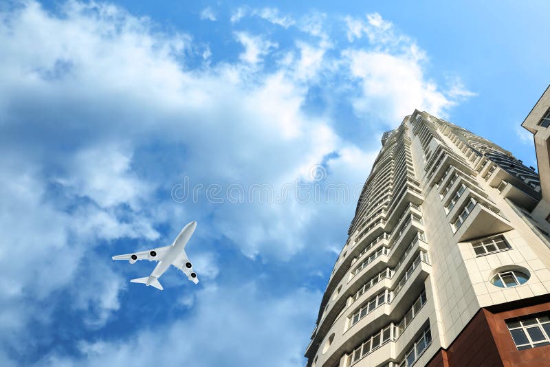Airplane Flying in Blue Sky Over Skyscraper Stock Image - Image of ...