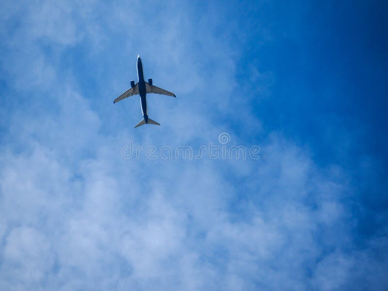 Airplane Flying in Blue Sky Stock Photo - Image of tourism, blue: 83679602
