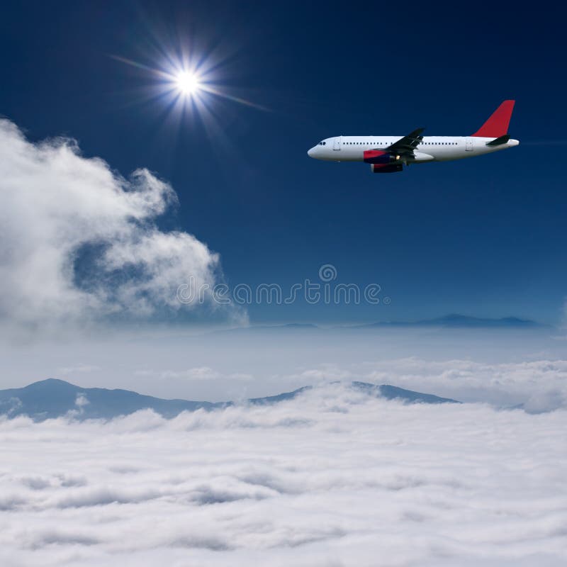 Airplane Flying at High Altitude Above the Clouds Stock Photo - Image ...