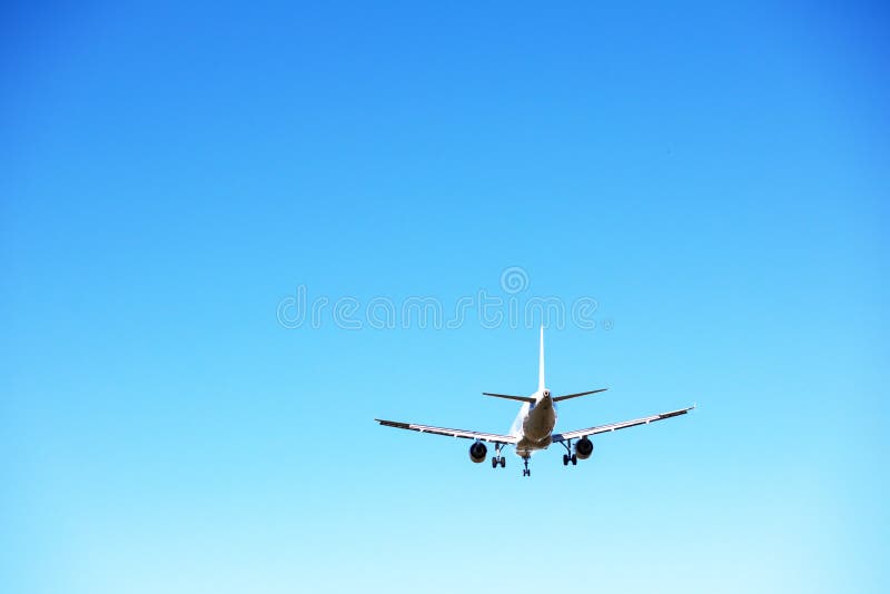 An Airplane Flying in the Lighht Blue Sky without Any Clouds Stock ...