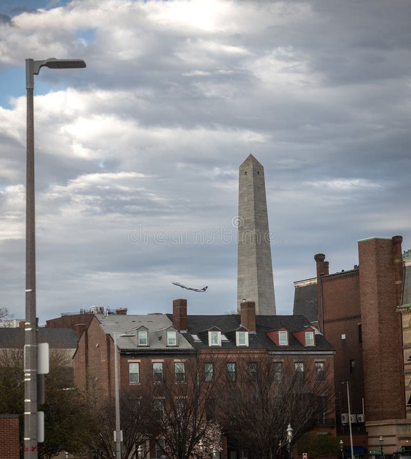 Airplane Flying Over the Bunker Hill Monument in Boston with a Cloudy ...