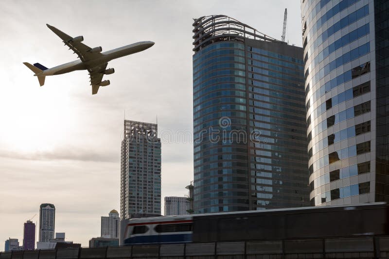 Airplane Flying Over City with Sky Train Stock Photo - Image of rail ...
