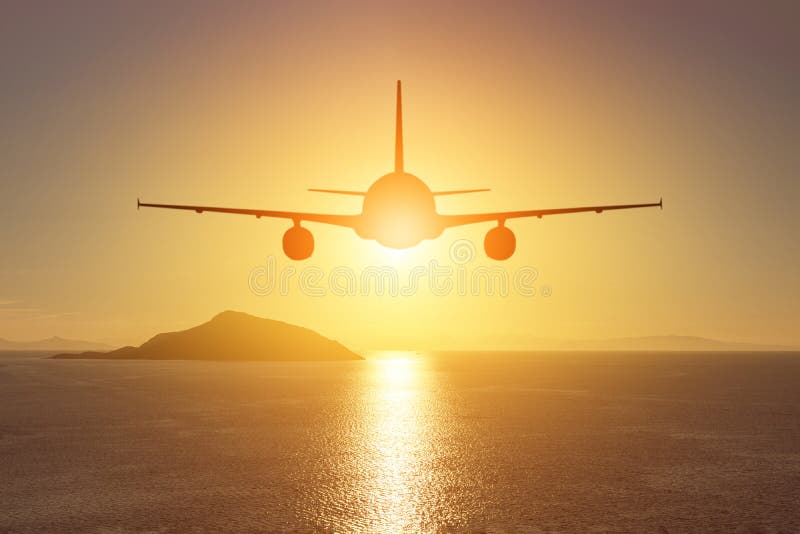 Airplane Flying Over the Sea at Sunset. Travel Concept Stock Photo ...