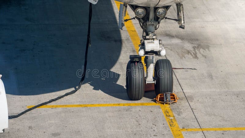 Airplane Front Chassis Parked in Airport during Airplane Checking and ...