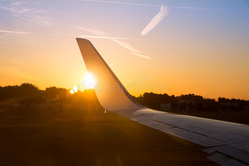 Airplane Jet Wing at Sunset with Golden Sunlight Stock Photo - Image of ...