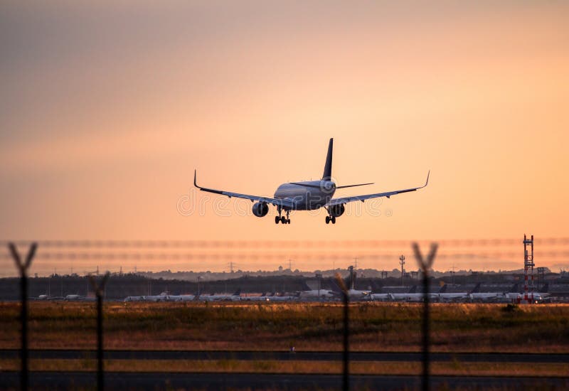 Airplane landing at sunset stock photo. Image of airlines - 102429268