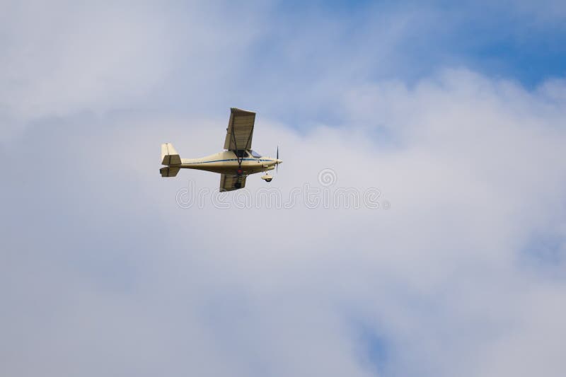 Airplane with Landing Gear Down Flying in Blue Sky Stock Image - Image ...