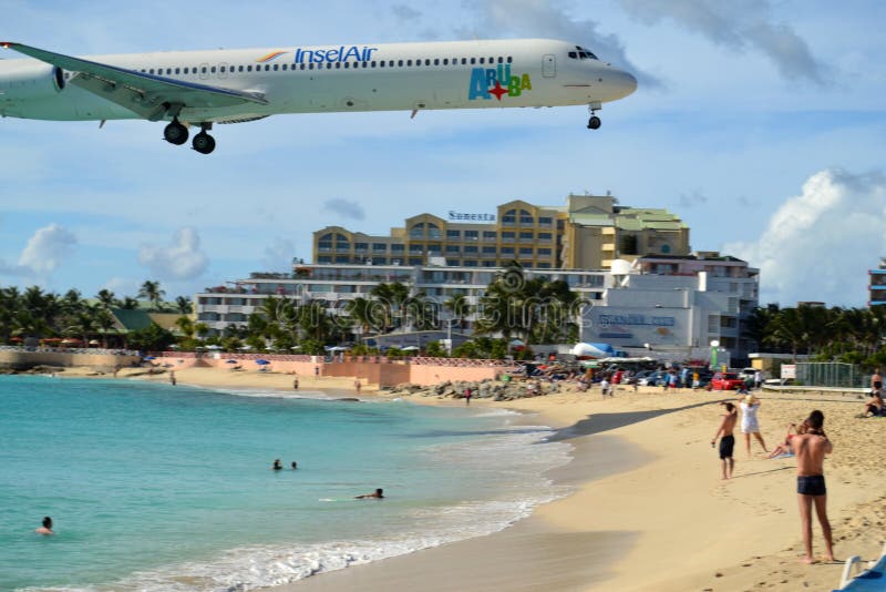 Airplane Landing Over Busy Beach Editorial Image - Image of landing ...