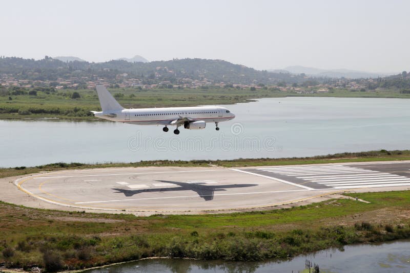 Airplane Landing on a Runway Stock Image - Image of terminal, travel ...