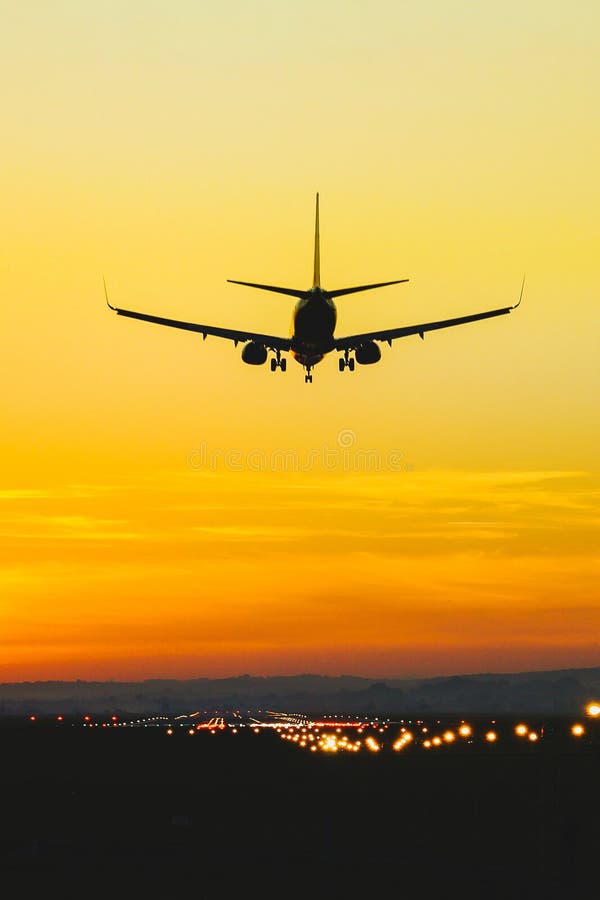 Plane Landing At Sunset