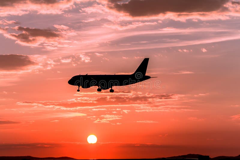 Airplane landing at sunset stock image. Image of passenger - 101132729