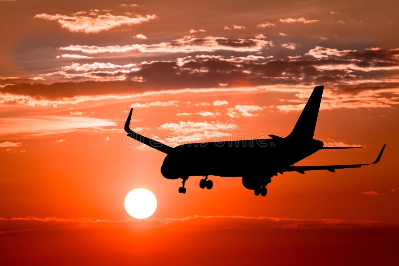 Airplane landing at sunset stock photo. Image of airliner - 89739960