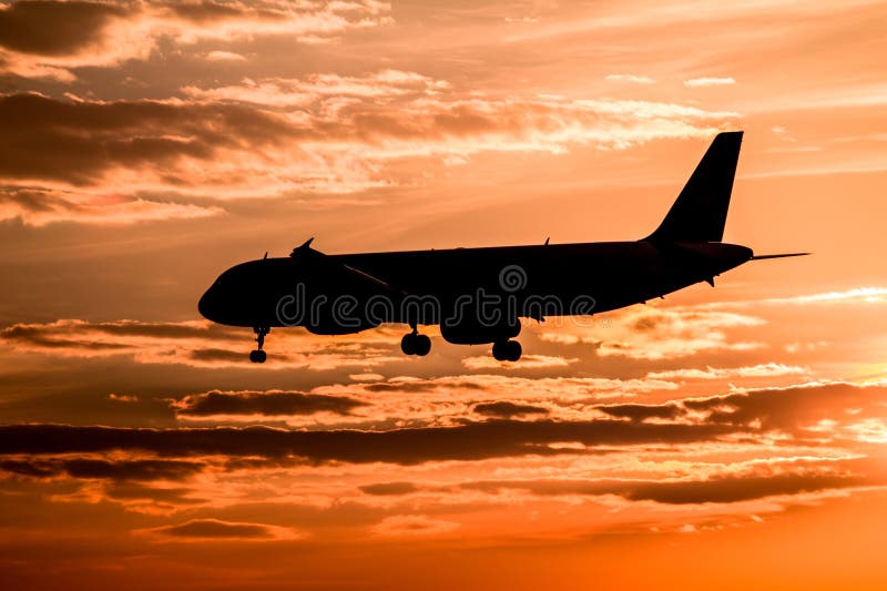 Airplane landing at sunset stock image. Image of nature - 92582877