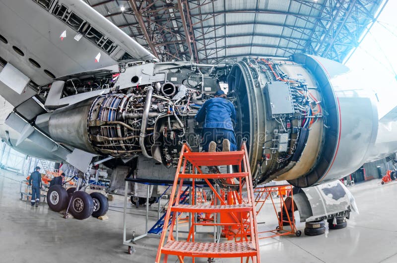 Airplane Mechanic Diagnose Repairs Jet Engine through Open Hatch. Stock ...