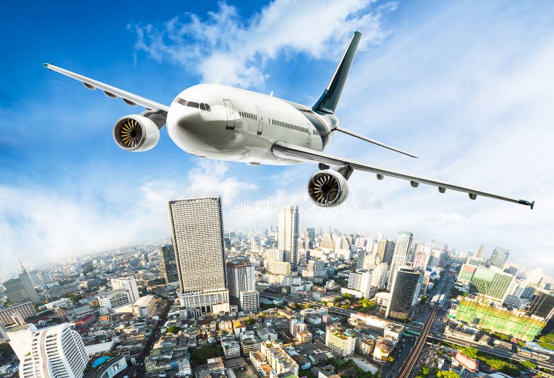 Airplane over cityscape stock photo. Image of skyscraper - 64023162
