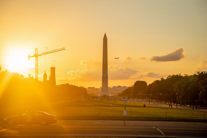 Airplane Passing Over Washington Monument at Sunset Stock Photo - Image ...