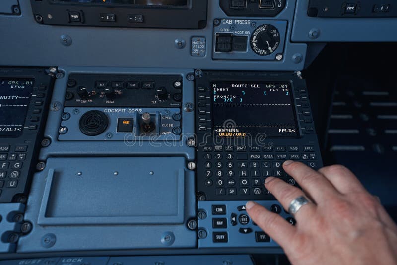 Pilot Inserting Flight Information into Plane System Stock Photo ...