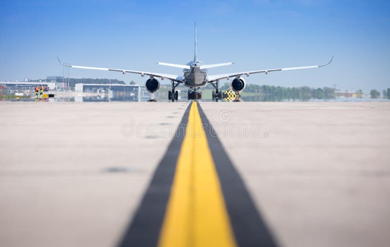 Airplane on a runway stock photo. Image of sunset, runway - 115581636