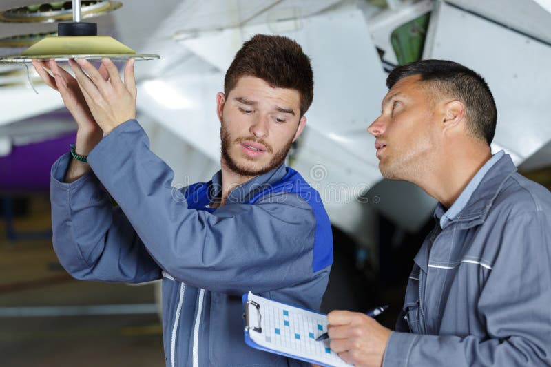 Airplane Service Crew Repairing Plane in Hangar Stock Image - Image of ...