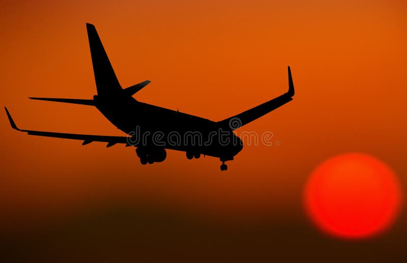 Airplane Silhouette Going Towards the Sun at Dusk Stock Image - Image ...