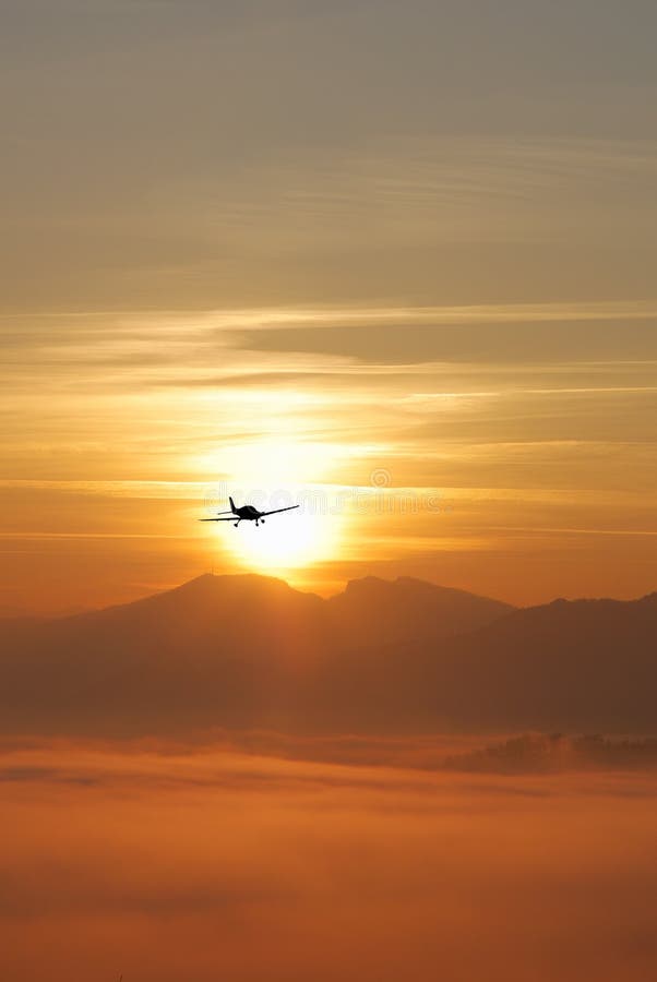 Airplane into the sunset stock photo. Image of orange - 13359278
