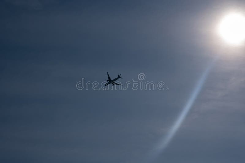 An Airplane in the Sky with Sun Stock Image - Image of plane, service ...