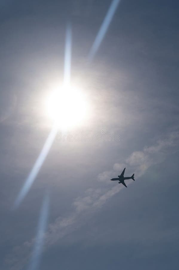 An Airplane in the Sky with Sun Stock Photo - Image of traffic, tourism ...