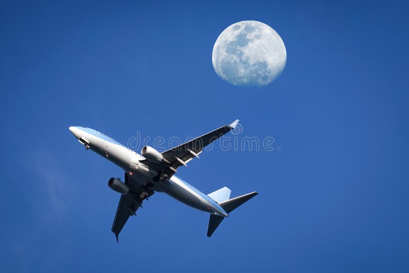 Airplane Soaring through the Moon on Blue Sky Stock Photo - Image of ...