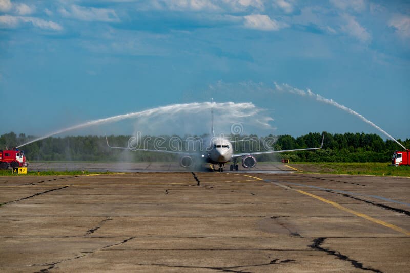 Airplane Spraying Water on the Runway of the Airport in the Summer ...