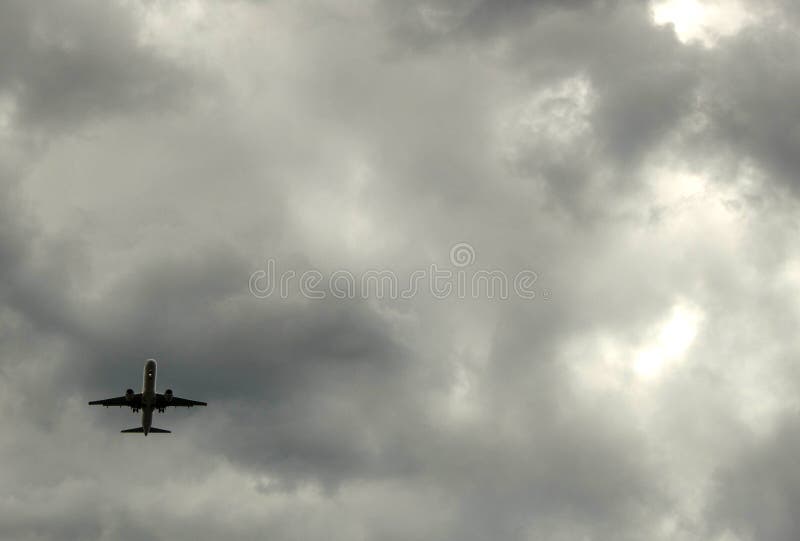 Airplane in storm clouds stock photo. Image of atmosphere - 116986984
