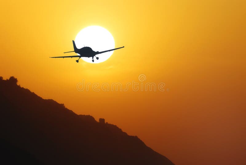 Airplane into the sunset stock photo. Image of orange - 13359278