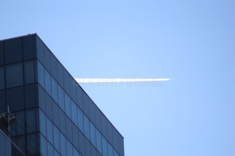 The Airplane Track Behind the Glass Building Stock Image - Image of ...