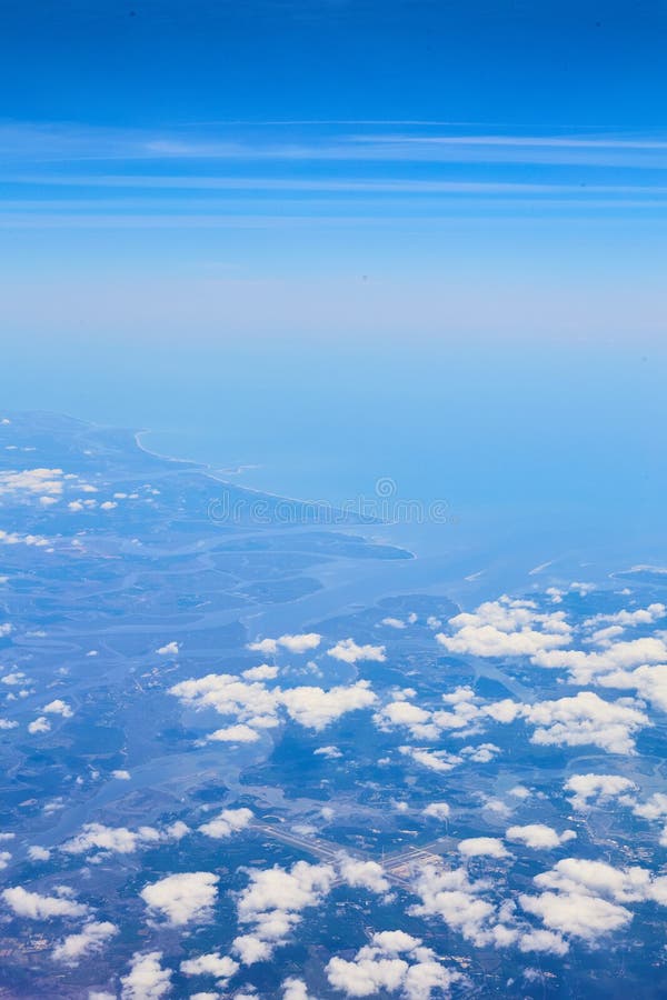 Airplane View of Clouds and Blue Sky with Land in Distance Stock Image ...