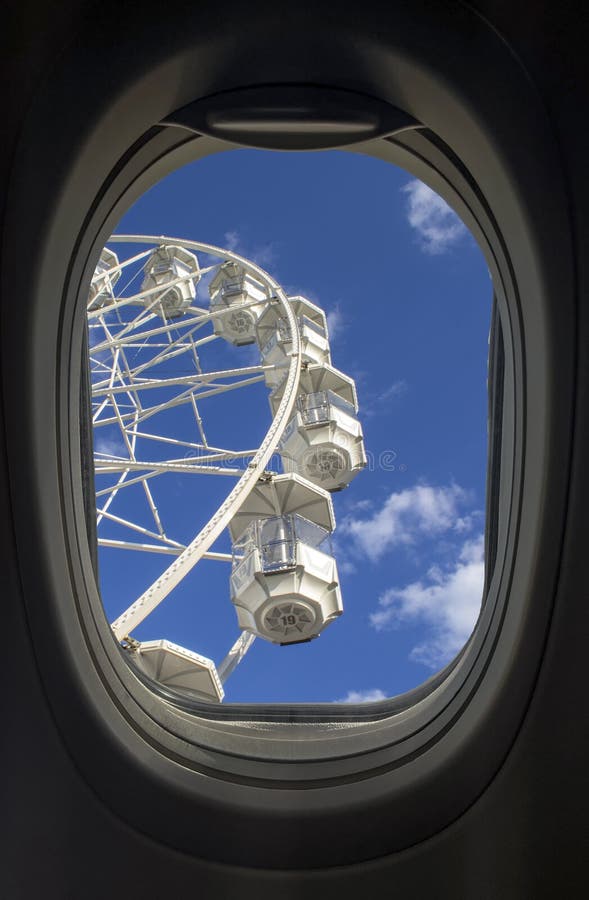Airplane Window. Ferris Wheel with Clouds in the Window of the Aircraft ...