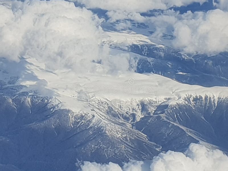 Sky high, snow, mountains stock image. Image of shots - 125647887