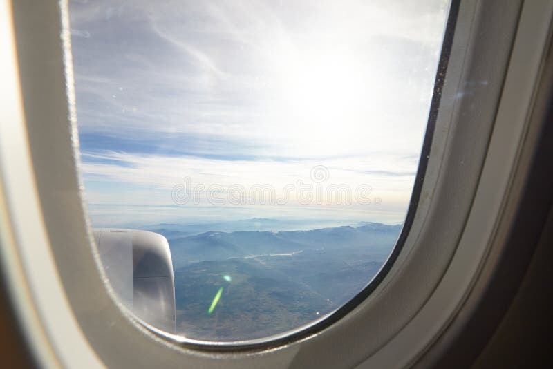 Airplane Window. View of the Engine and Landscape with the Sun Shining ...