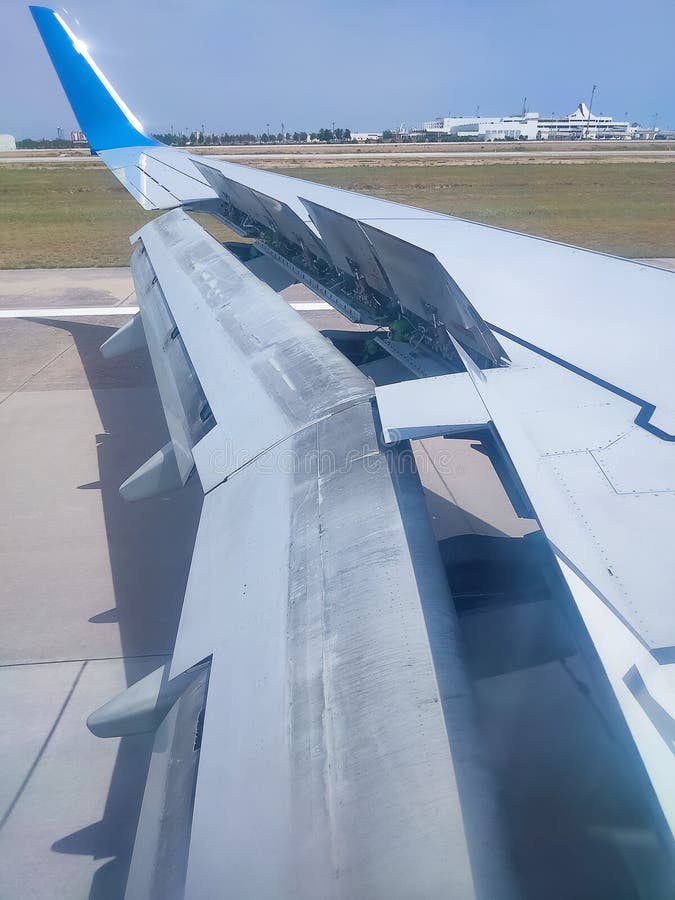 An Airplane Window View of Wing and Flaps after Landing. Stock Image ...
